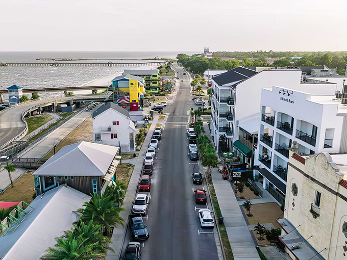 From above, this coastal town reveals its perfectly organized grid, where modern buildings and waterfront living meet like successful blind dates.