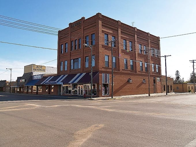 This corner building anchors Bottineau's downtown like a reliable friend, while Ace Hardware promises practical solutions nearby.