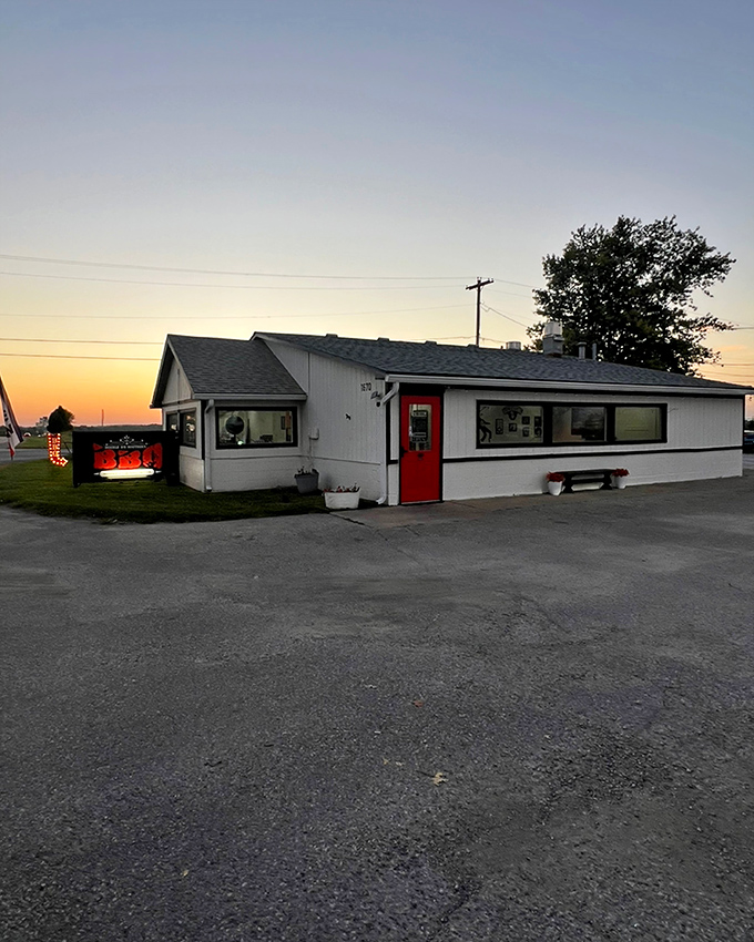 This little white BBQ house glows at sunset like it's illuminated by the embers of its own smoker. Small building, big flavors waiting inside.