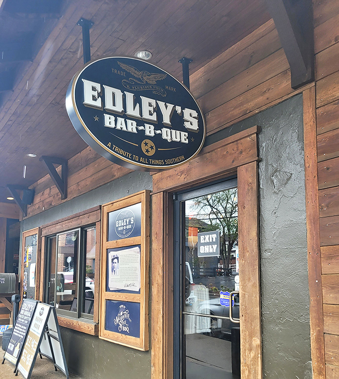 That elegant black sign against natural wood tells you Edley's takes barbecue seriously – without taking itself too seriously.