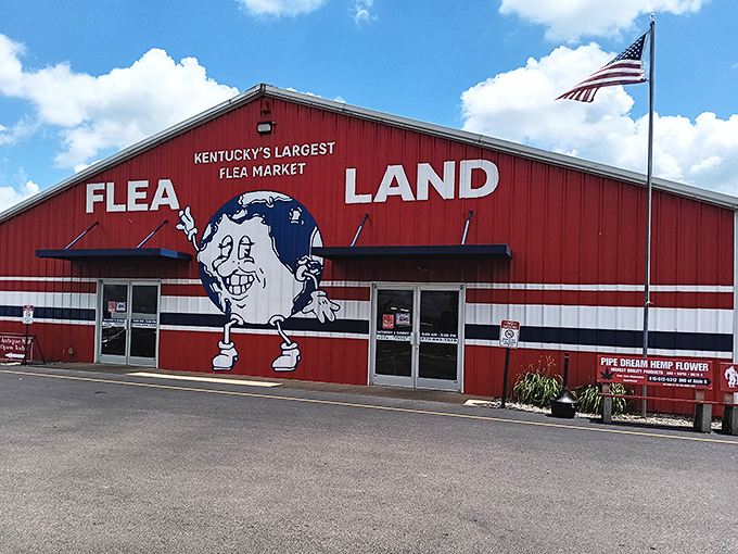 Two American flags frame the entrance like patriotic sentries guarding a kingdom of second-hand treasures.