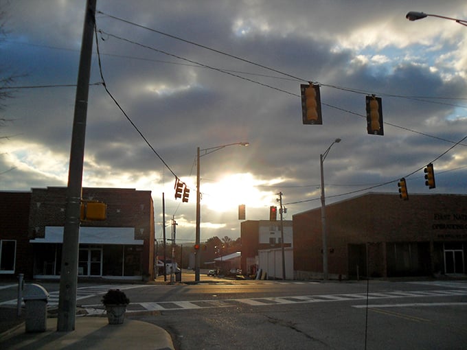 Dramatic skies frame Hamilton's intersection like nature's own spotlight on small-town America's enduring appeal.