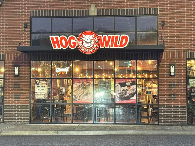 Evening at Hog Wild BBQ brings the neon glow and promise of smoky treasures. Simple exterior, complex flavors waiting inside.