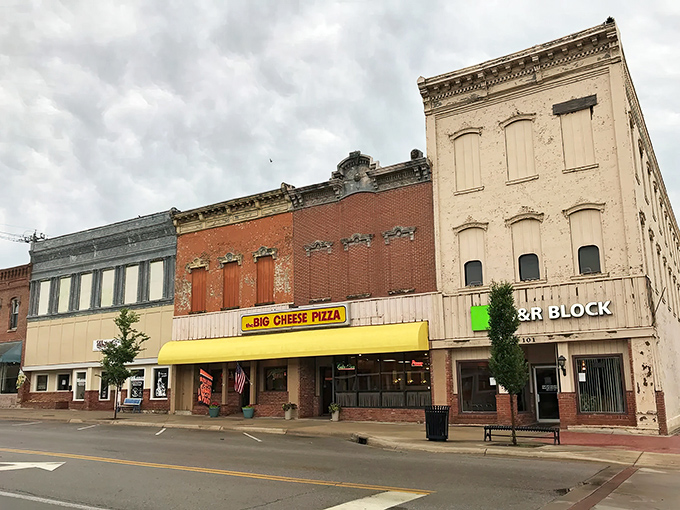 A bright yellow awning and well-maintained storefronts show a community that takes pride in its appearance.