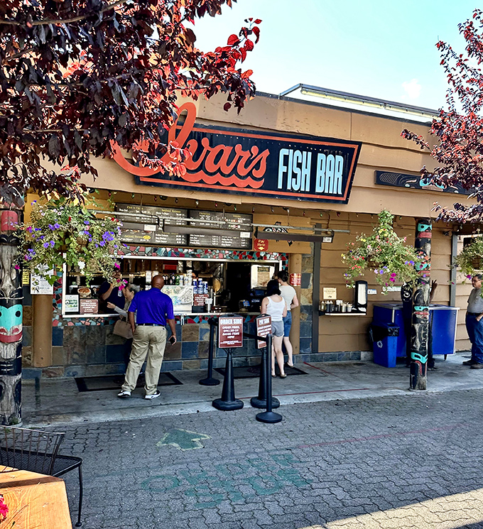 That iconic red sign signals Seattle seafood tradition where tourists and locals unite over perfect plates.