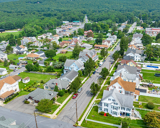 Those tree-covered hills cradle this town like Mother Nature's own protective embrace.