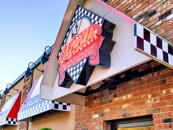 With its retro checkered awning and bold neon glow, this spot serves up New York–style pizza with big flavor and even bigger personality.