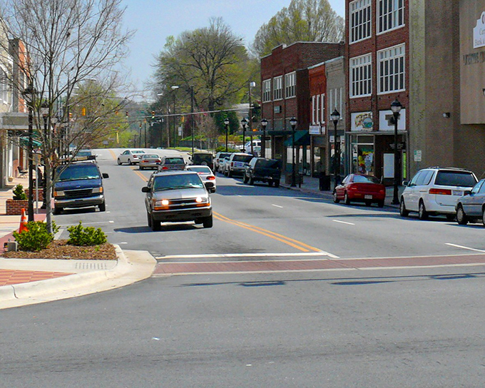 The brick buildings of Lenoir stand shoulder to shoulder like old friends who've weathered storms together for generations.