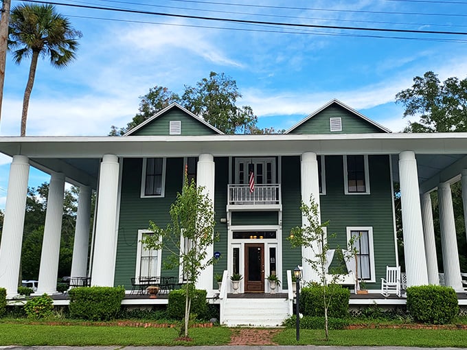 Classic Southern architecture shines in this green historic home with white columns, where front-porch sitting is practically mandatory.