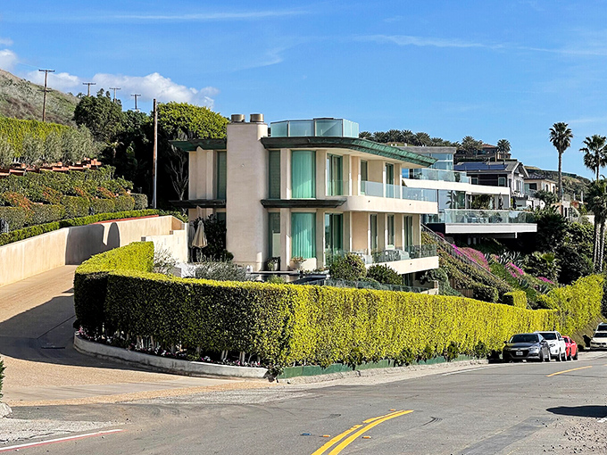 Modern beach houses perch on hillsides with views that probably cost more than most people's entire retirement fund.