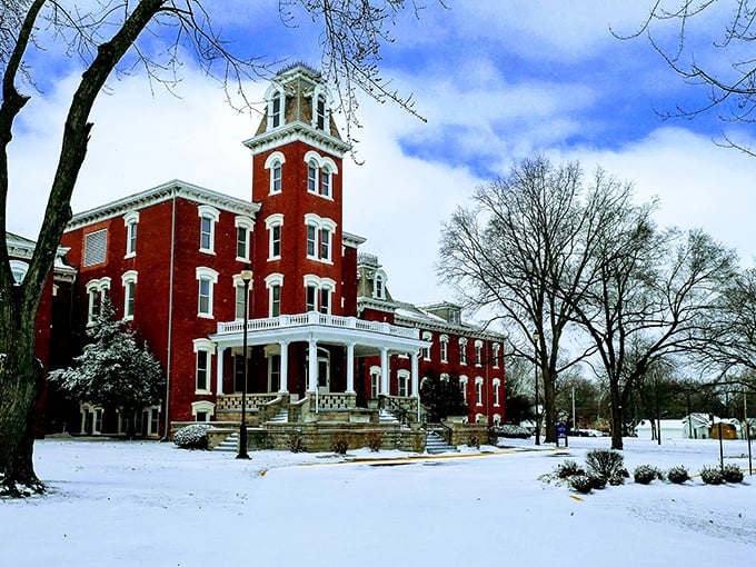 Winter wonderland! Snow blankets the grounds of this impressive red brick building in Nevada, creating a postcard-perfect Missouri scene.