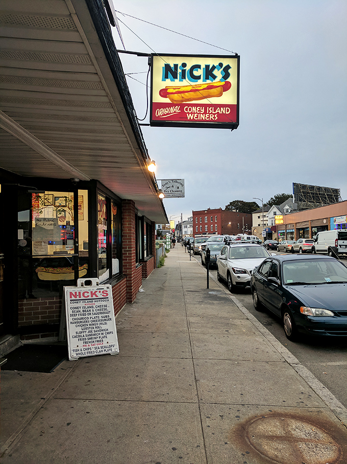 As evening falls, this unassuming storefront transforms into a beacon of hope for those craving the perfect Coney dog.