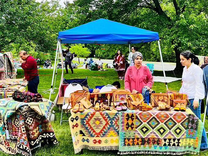 Colorful textiles and artisan goods transform simple white tents into galleries showcasing local creativity and cultural heritage.
