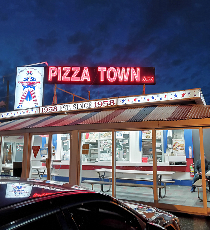 Pizza Town USA lights up the night with neon nostalgia. This time capsule of flavor proves some things never need changing.
