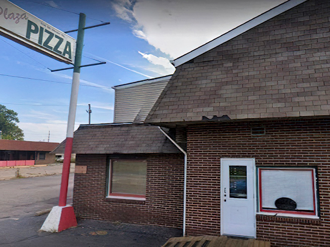 Plaza Pizza: That simple "PIZZA" sign against the winter sky promises warm, cheesy comfort inside when you need it most.