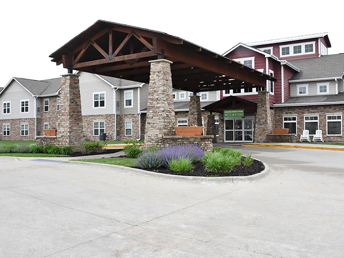 The impressive covered entrance at Prairie Vista offers a grand welcome while showcasing the community's attention to architectural detail.