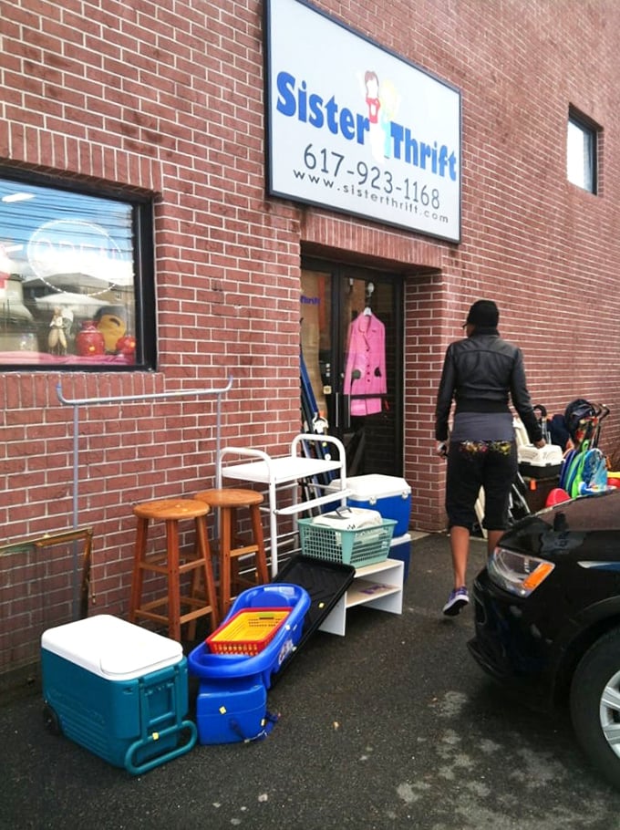 The sidewalk display at Sister Thrift tempts passersby with colorful household goods. That pink jacket in the window might be your next find!