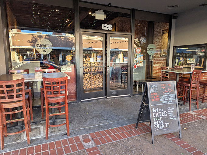 Historic charm meets smoky goodness at Smoqued, where outdoor tables invite you to savor BBQ in Orange's sunshine.