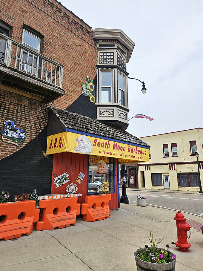 The bright yellow awning and vintage brick building house barbecue magic that makes waiting in line feel like winning the lottery.