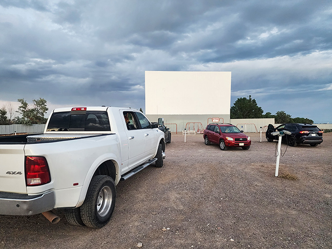 Trucks line up at the Star Drive-In as the sky darkens, transforming an ordinary field into cinema magic.
