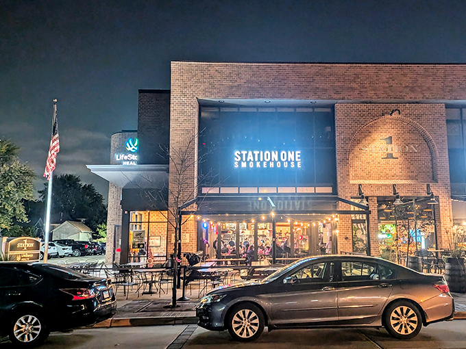 As night falls, Station One Smokehouse glows like a beacon for barbecue lovers seeking refuge from ordinary dining experiences.