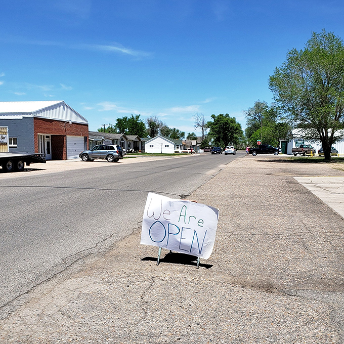 Hand-written signs announce businesses open for neighbors who appreciate honest work and fair pricing always.