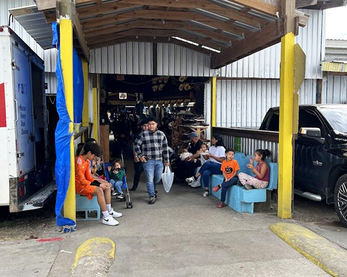 Colorful umbrellas create an artistic ceiling while shoppers browse endless rows of bargains below.