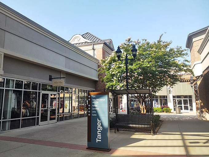 Dappled sunshine between storefronts&mdash;nature's way of highlighting your path to the next great deal.