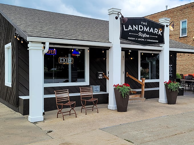 Daytime reveals The Landmark's charming storefront &ndash; where those sidewalk seats promise people-watching with your perfectly cooked ribeye.