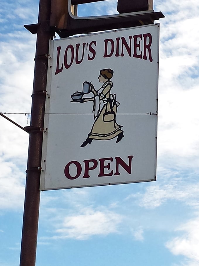 The vintage sign at Lou's features a server rushing to deliver hot plates. A perfect symbol of this diner's dedication to timeless breakfast service.