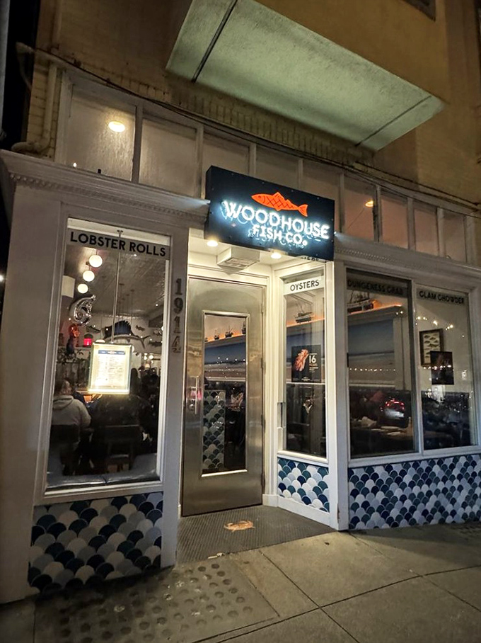 Nighttime transforms Woodhouse Fish Co. into a glowing seafood beacon. The illuminated sign calls to hungry San Franciscans like a dinner bell.