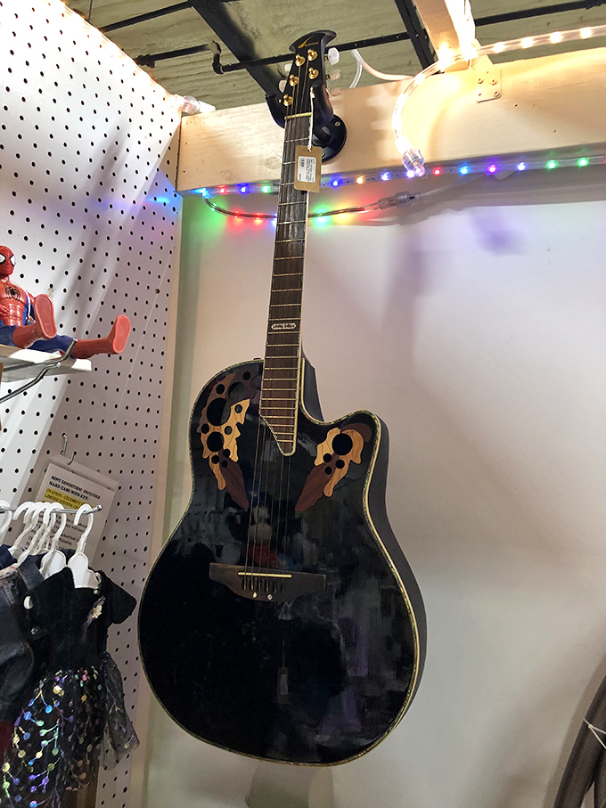 This isn't just any guitar&mdash;it's someone's abandoned rock star dreams hanging on display, waiting for fingers that might finally make it famous.