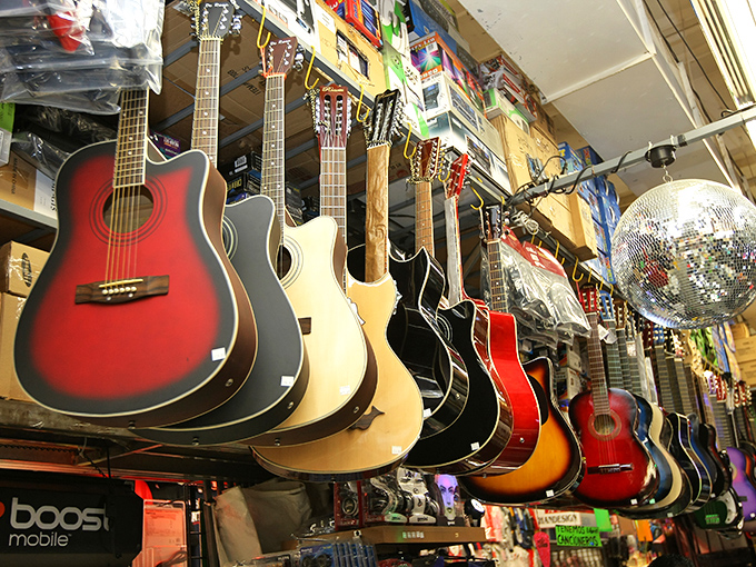 Guitars waiting for their next serenade, hanging like musical fruit ready to be plucked by aspiring mariachis and rock stars alike.