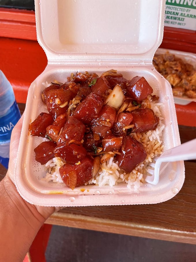 Ruby-red cubes of ahi tuna glisten with marinade, perched atop a bed of rice. This is Hawaii's soul in a takeout container.