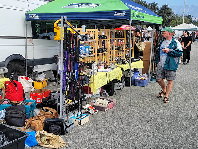 Beneath the Seattle Seahawks tent, outdoor gear awaits its next adventure. One person's unused camping equipment is another's ticket to wilderness exploration.