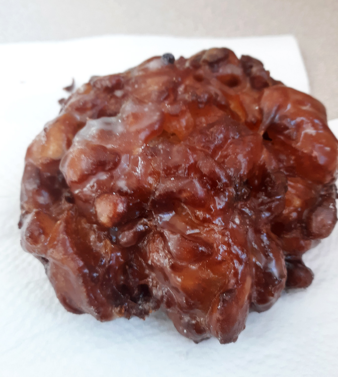 This apple fritter isn't just a donut &ndash; it's a glistening, caramelized monument to what happens when apples fulfill their highest purpose.