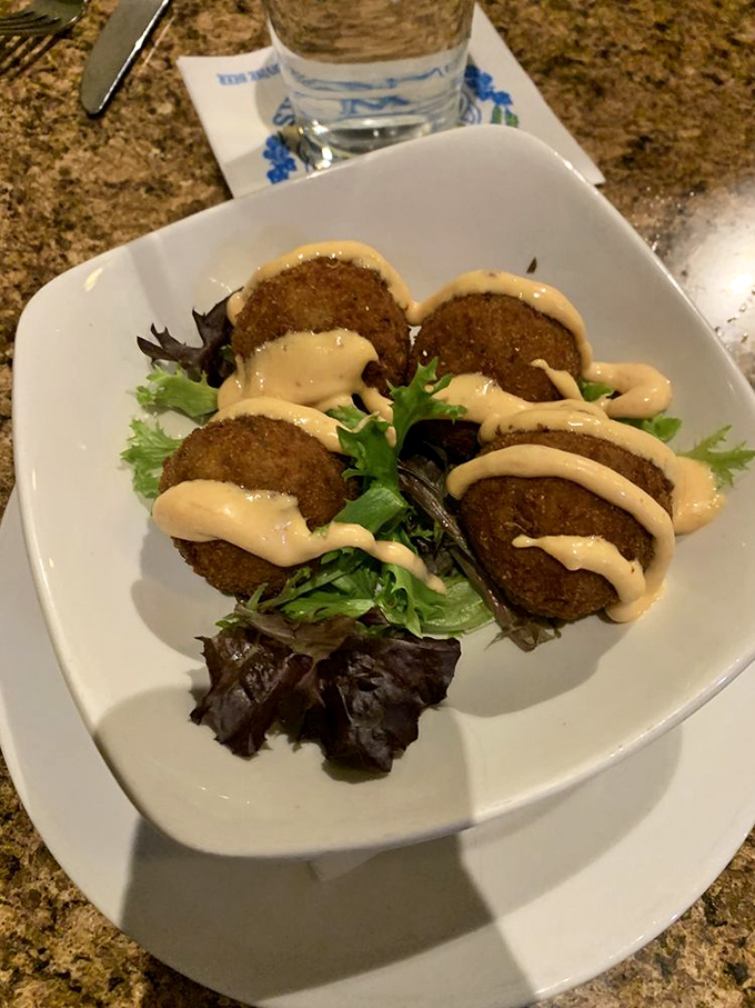 Golden-fried arancini balls drizzled with sauce that would make even the most devout Italian grandmother weep with joy.