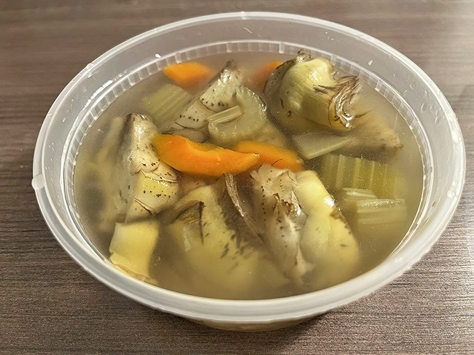 Clear artichoke soup—where you can actually see the vegetables swimming happily alongside carrots and potatoes in a broth that tastes like sunshine.