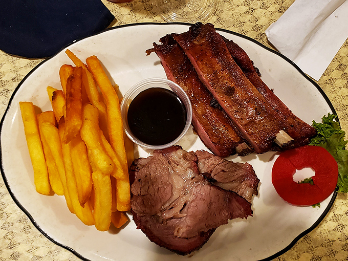 The holy trinity of barbecue &ndash; ribs, beef, and fries &ndash; arranged with the care of a Renaissance painter who understands that true beauty comes with sauce on the side.