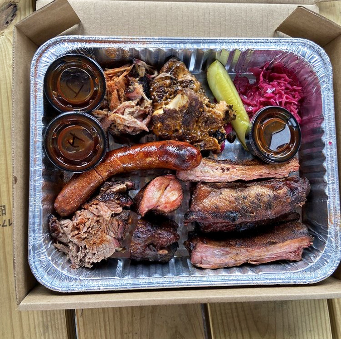 The barbecue sampler that dreams are made of&mdash;complete with sausage, ribs, pulled pork, and those vibrant pickled onions.