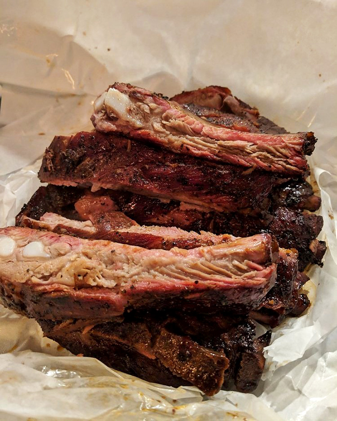 These ribs glisten like mahogany treasures, each bone a handle to happiness.