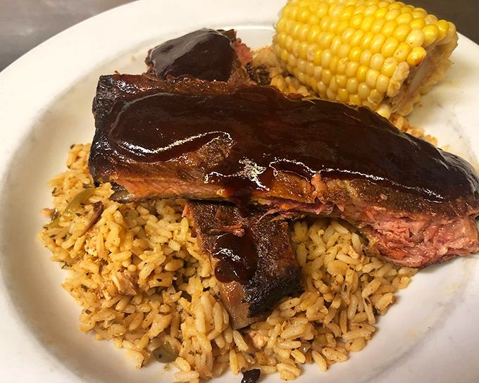 BBQ ribs lounging on a bed of rice like they own the place, glistening with sauce that means business.