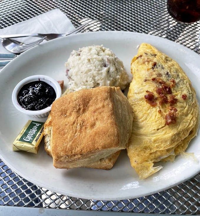 The breakfast trinity: a fluffy omelet, buttery biscuit, and winter squash side that would make even your grandmother nod in respectful approval.