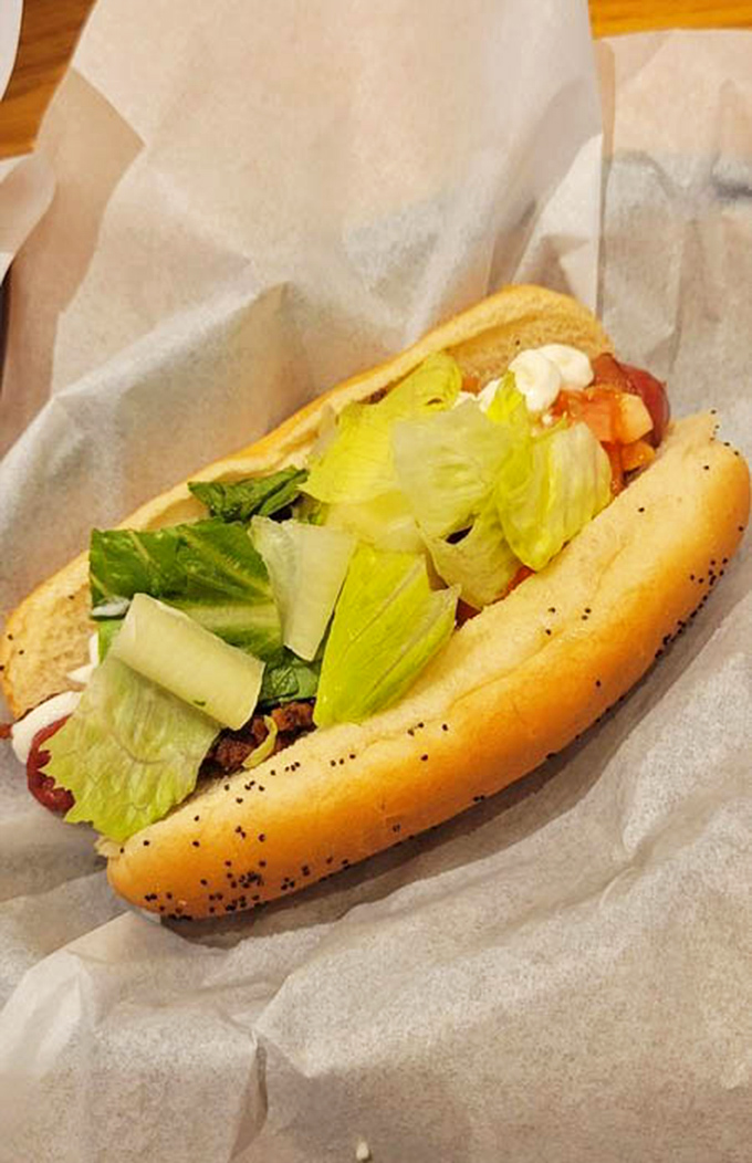 A hot dog dressed for success with crisp lettuce and fresh toppings&mdash;proof that sometimes the classics don't need reinvention, just quality ingredients.