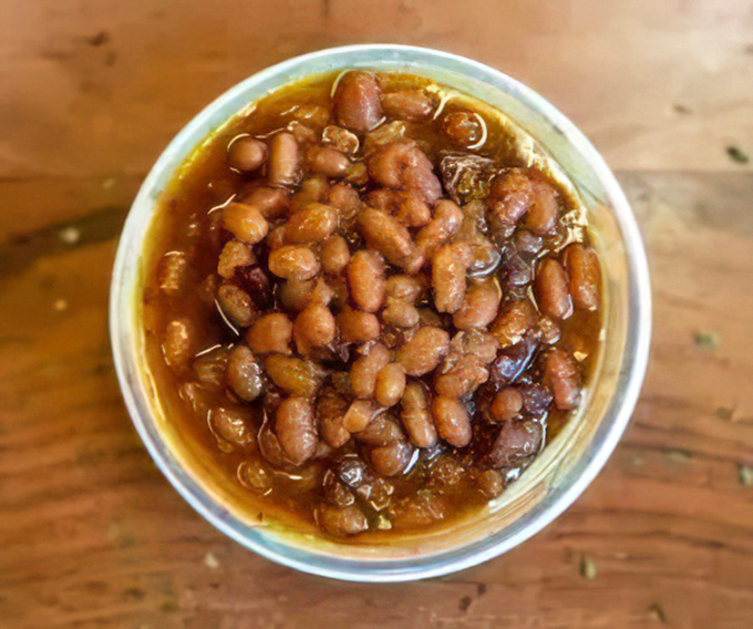 These baked beans have clearly been introduced to some smoky friends along the way&mdash;a neighborhood gathering in a cup.