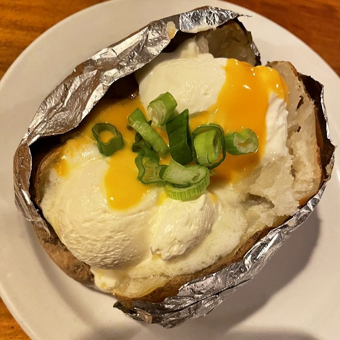 A loaded baked potato that's basically a warm, fluffy pillow stuffed with all the good things in life.