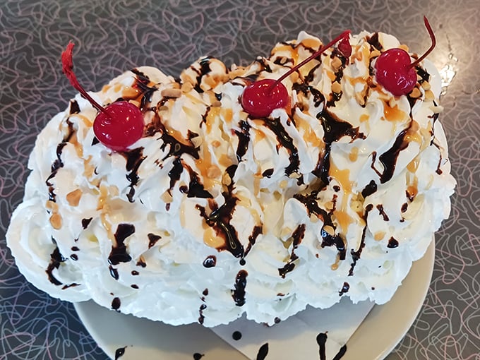 This banana split isn't just dessert, it's a architectural marvel of whipped cream, cherries, and enough toppings to require a building permit.