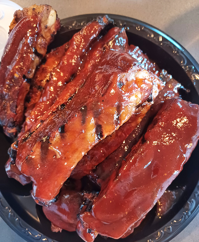 These ribs aren't just cooked; they've been coaxed into tenderness through a slow-dance of smoke and time that makes teeth purely optional.