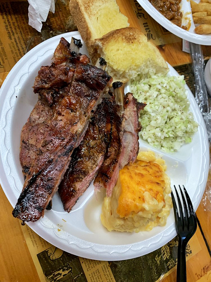 These ribs have the kind of smoke ring that makes barbecue enthusiasts weak in the knees, paired with sides that refuse to be overshadowed.