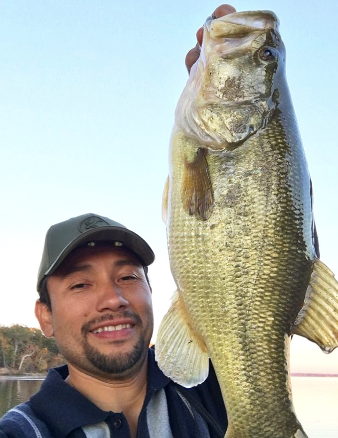 The universal "I caught something bigger than expected" smile. This bass clearly didn't read the memo about avoiding hooks.